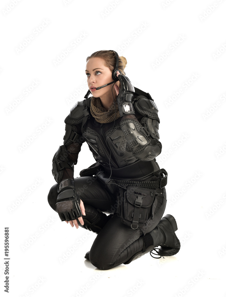 full length portrait of female soldier wearing black tactical armour ...