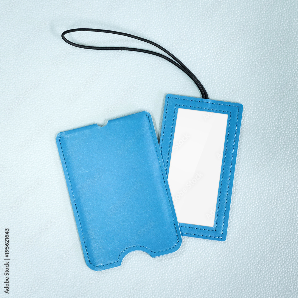 Blue leather hanging tag on synthetic background. Blank name tag for ...