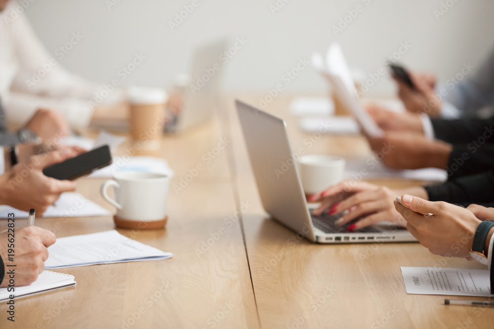 Business people sitting together at conference table office desk using ...