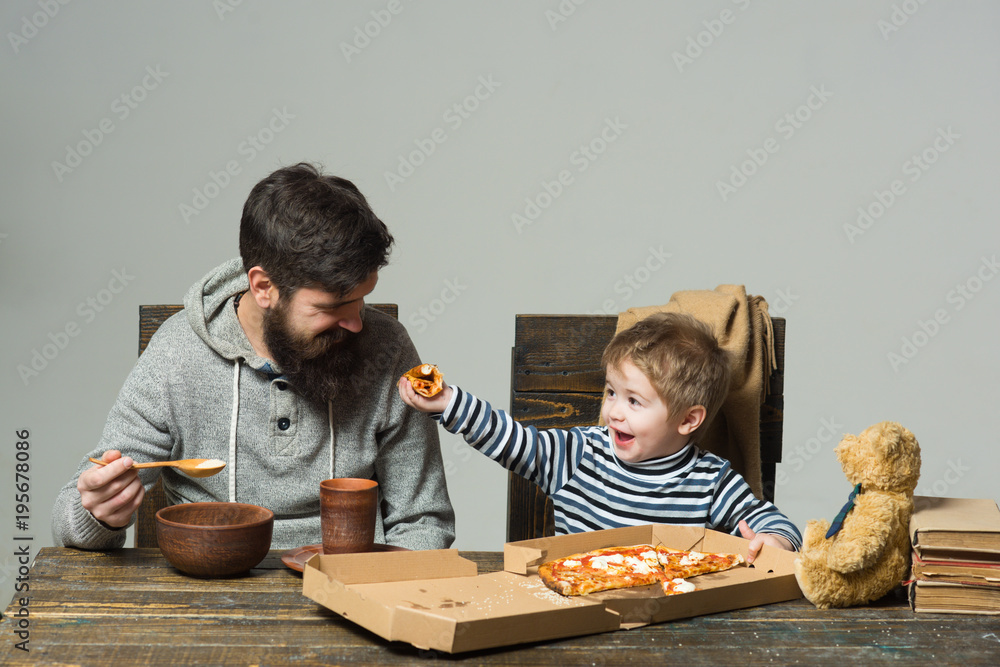 Happy father with child son eating pizza. Man and boy eating pizza at ...