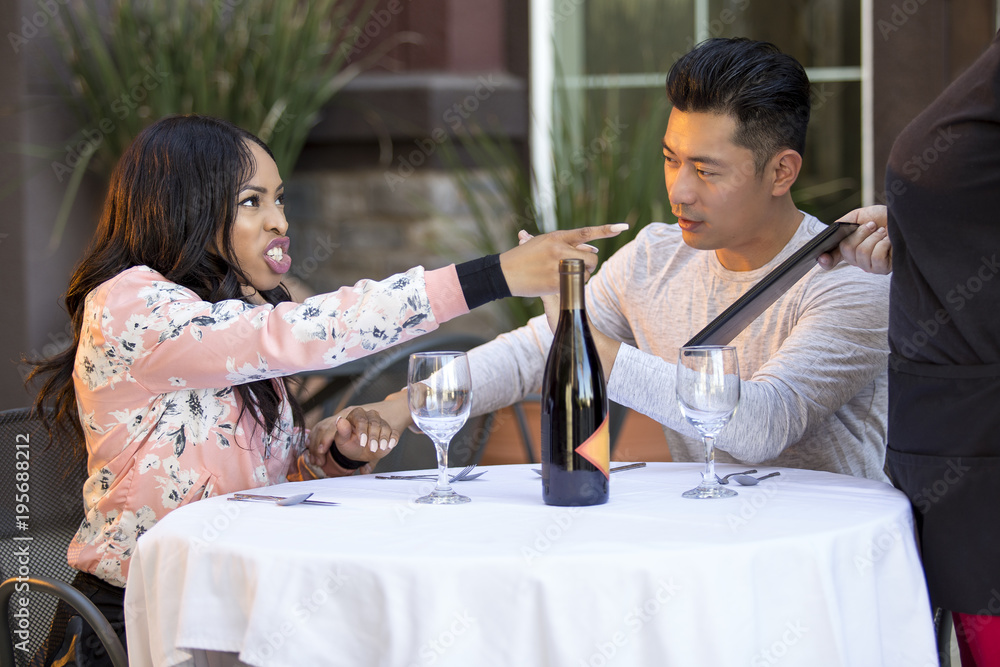 Rude girlfriend complaining to a waitress in a restaurant with an ...