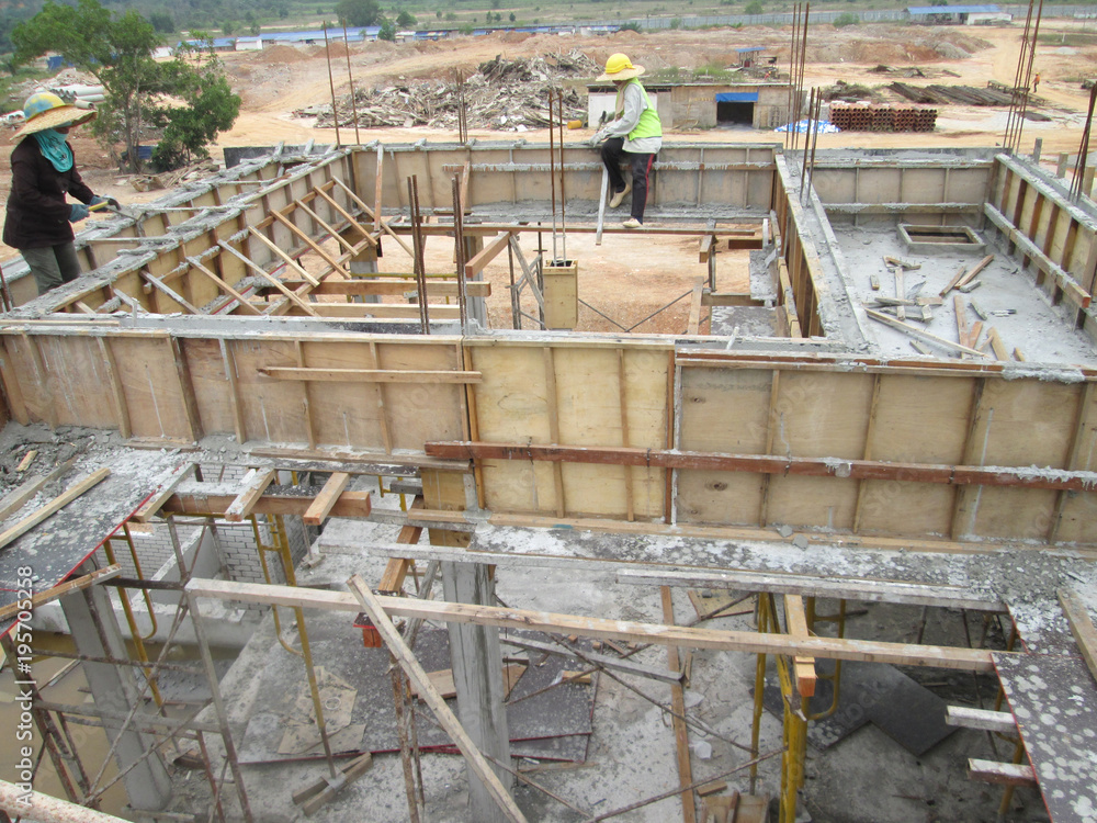 Construction workers fabricated timber form work at the construction ...