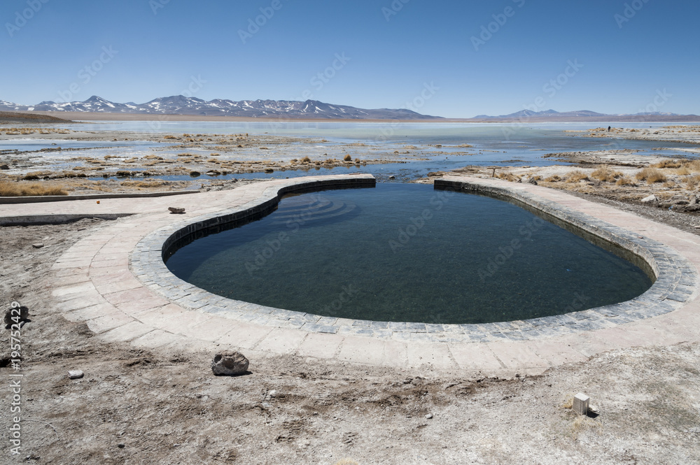 Laguna y Termas de Polques hot spring pool with Salar de Chalviri in ...