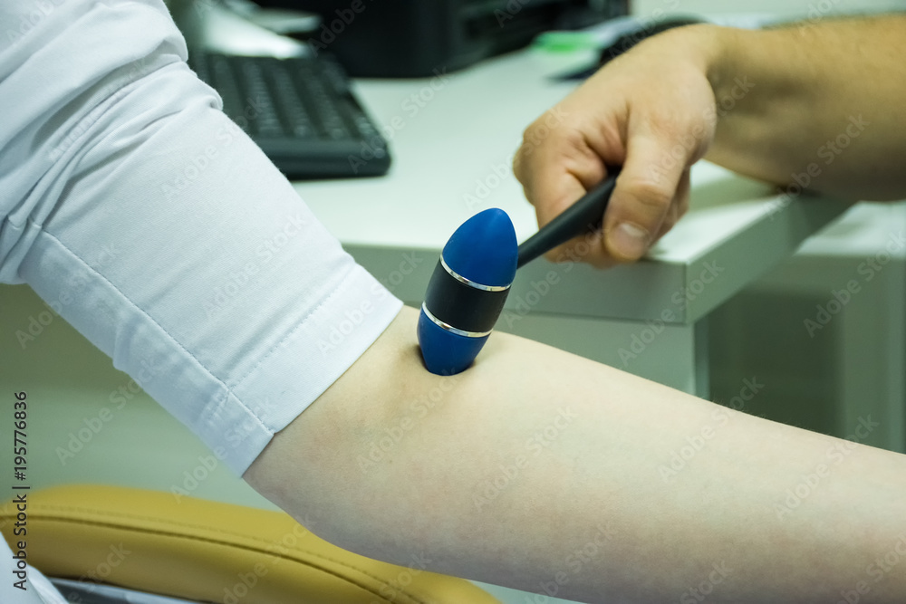 Neurological physical examination of the elbow flexion reflex. Doctor ...