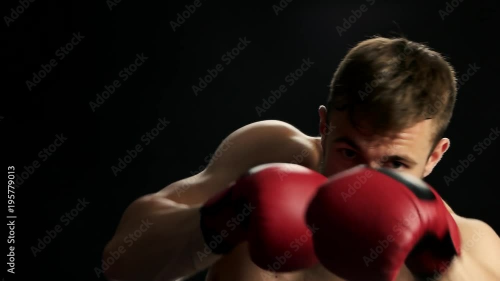 Double arm block boxing. Slow motion young boxer in red gloves having ...
