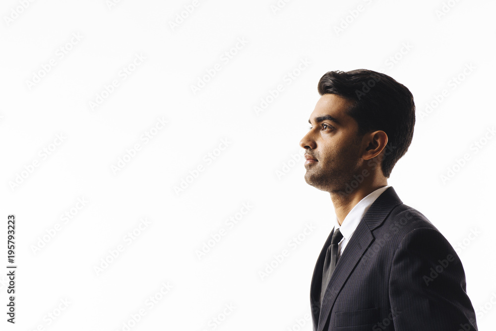 A profile portrait of a handsome man in suit and tie looking to side ...