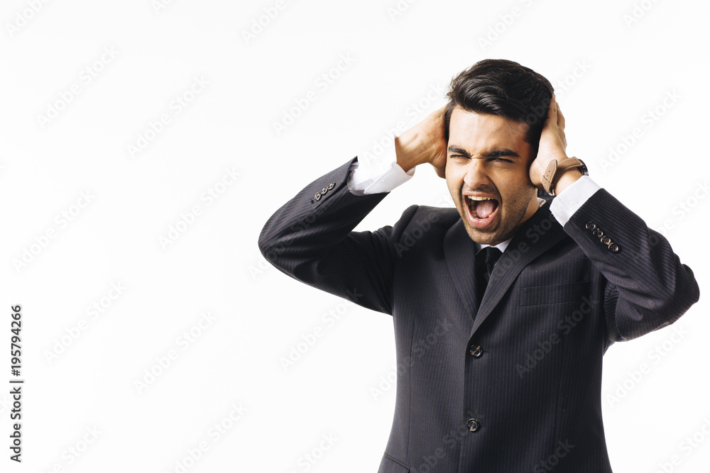 Stressed man in business suit and tie screaming and holding head ...