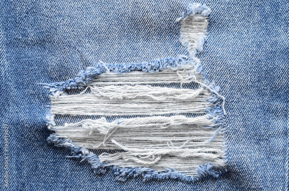 Jeans in wash blue with rip. Denim background, texture. Ripped ...