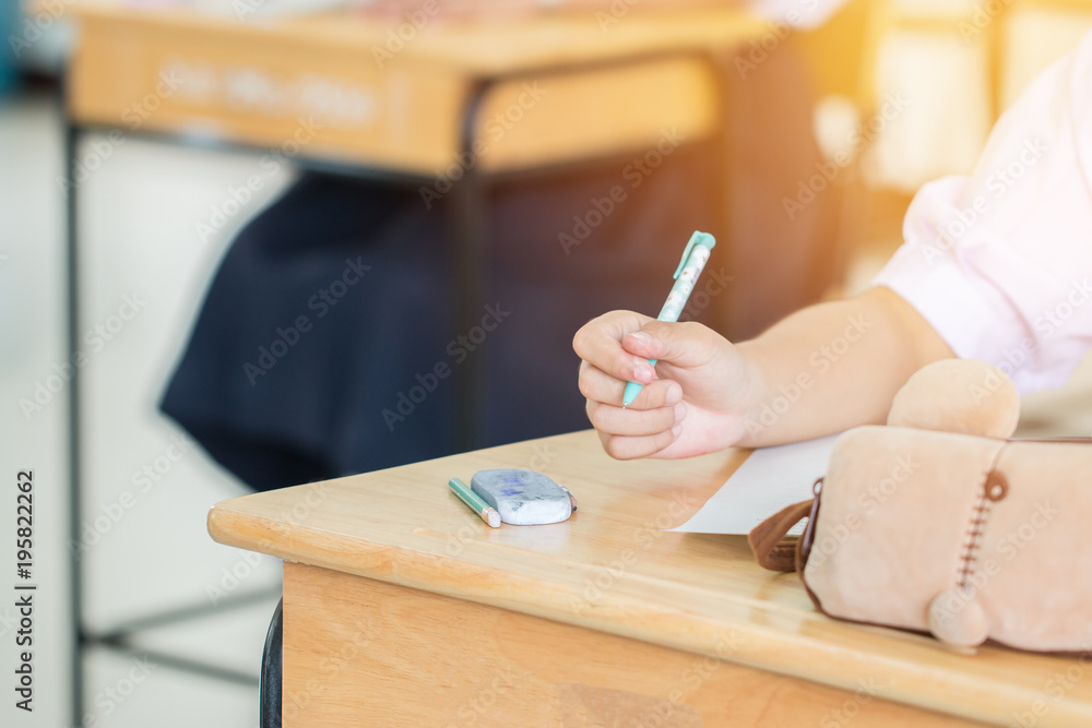 Students holding pen in hands taking exams, writing examination room ...