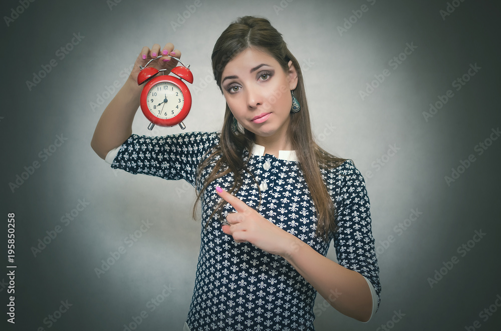 Strict boss woman holding in hands red alarm clock and showing time by ...