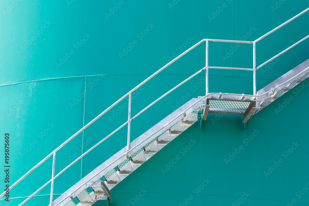 steel stair on green metal silo, metal ladder on green chemical ...