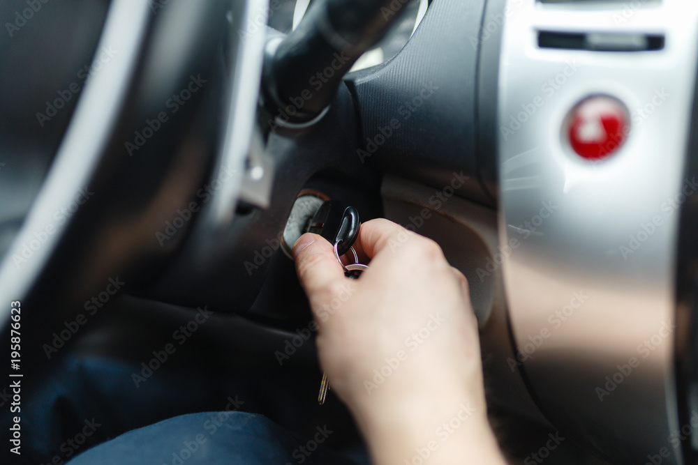 The driver of the man gets a car with a key. The hand inserts the key ...
