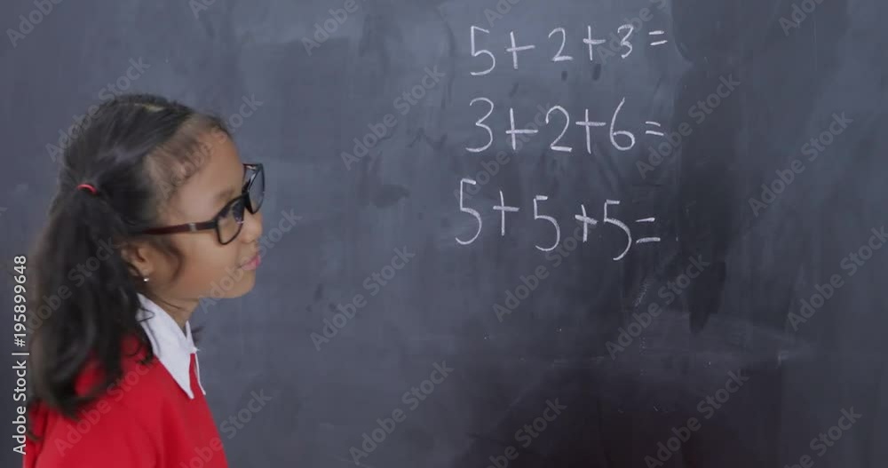 Stockvideo Confused female elementary school student solving a math ...