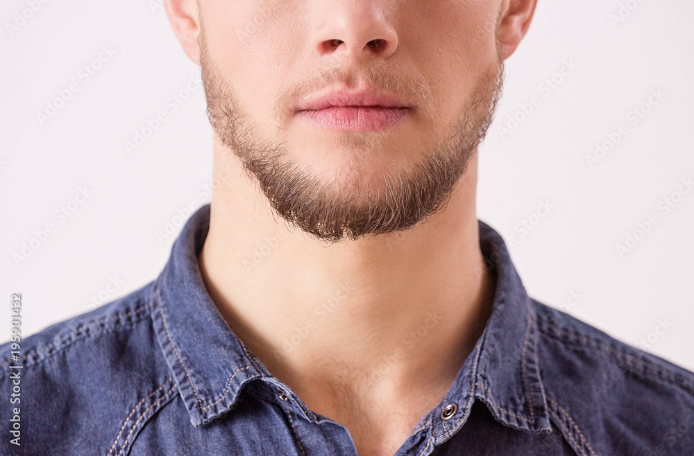 Close up of young unshaved man isolated over white background. Portrait ...