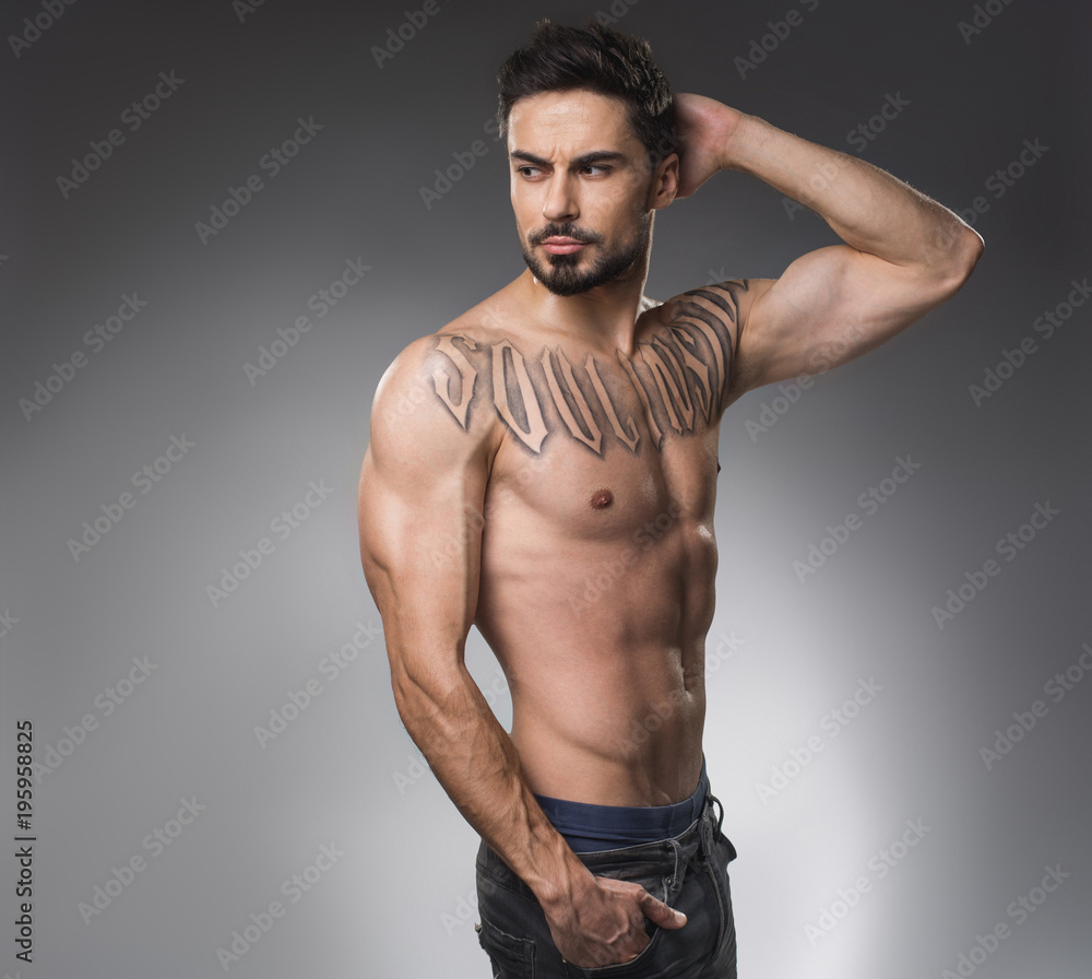 Portrait of calm handsome guy with developed definitions of muscles and ...