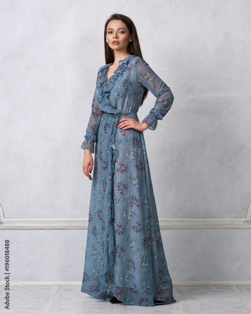 Full body portrait of attractive young woman posing in elegant maxi ...