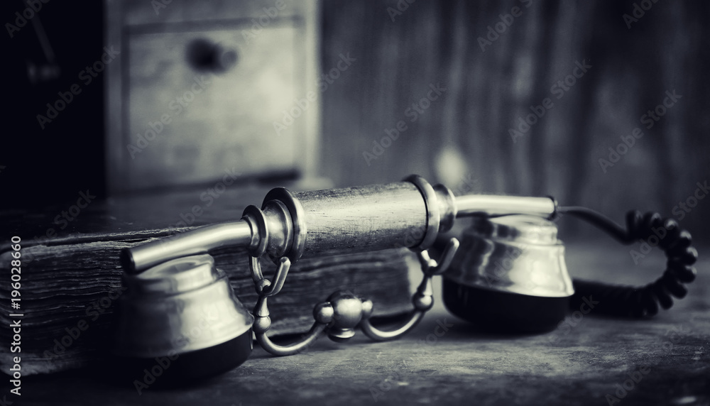 Old telephone and retro book on the desk. The phone of the past Stock ...