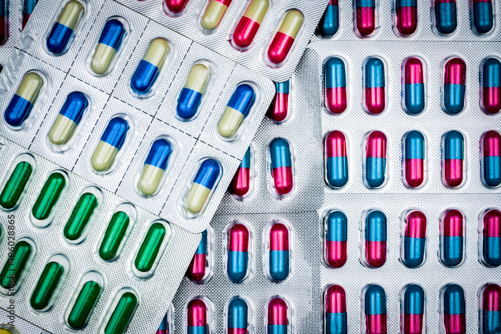 Top view of colorful tablets and capsules pills in blister packs ...