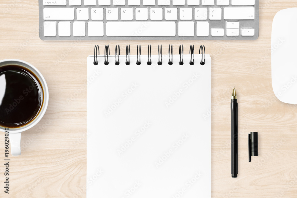 Blank notebook is on top of white office desk table with supplies. Top ...