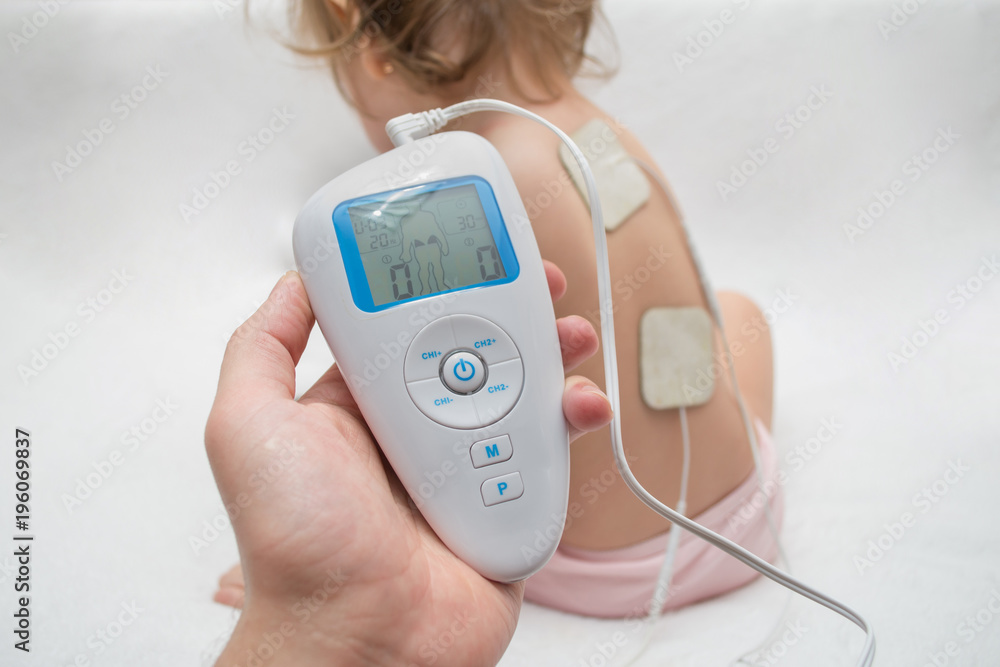 cute baby do electrophoresis using an electrical muscle massager Stock ...