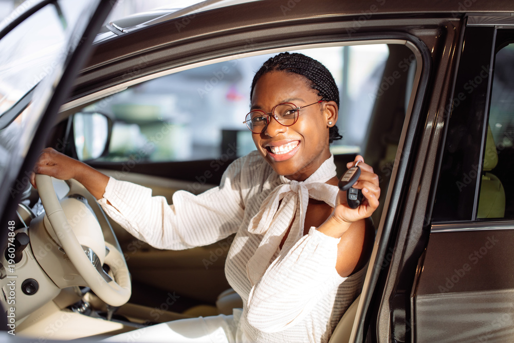 Beautiful young mixed race black African American woman driving car and ...
