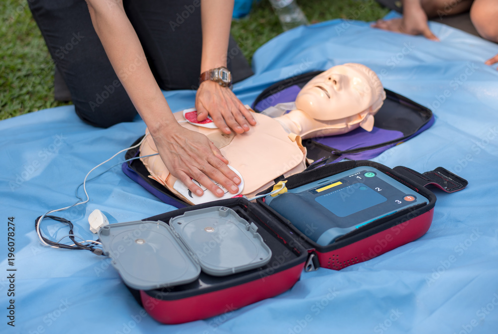 First Aid - CPR Training Chest Compression on Training Manikin with ...