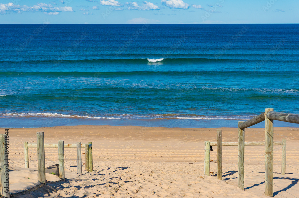 Beach entrance with wooden poles and ocean on the background Stock ...