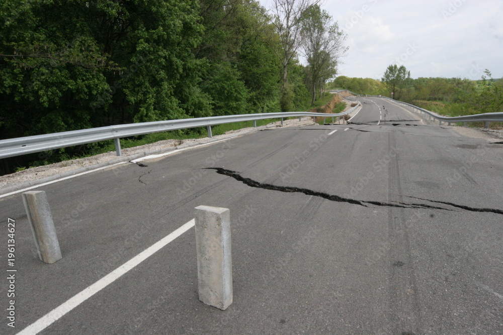 Road collapses with huge cracks. International road collapsed down ...