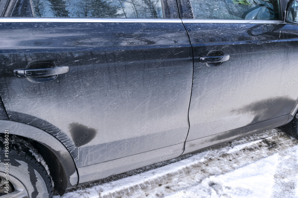 Side view of a very dirty car. Fragment of a dirty SUV. Dirty doors ...