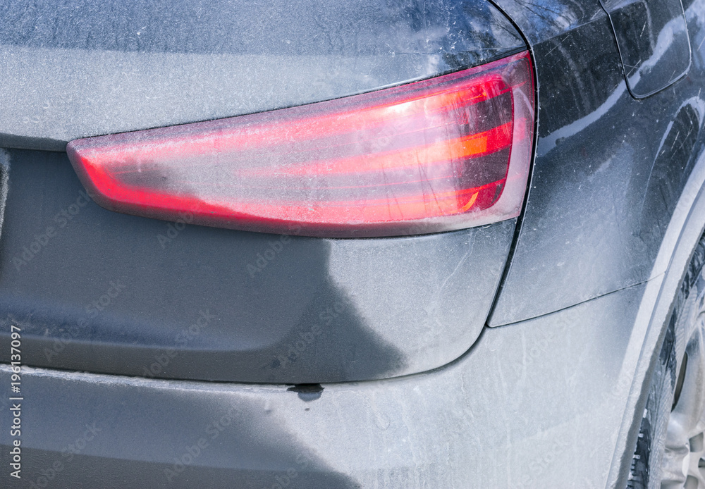 Back view of a very dirty car. Fragment of a dirty SUV. Dirty rear ...