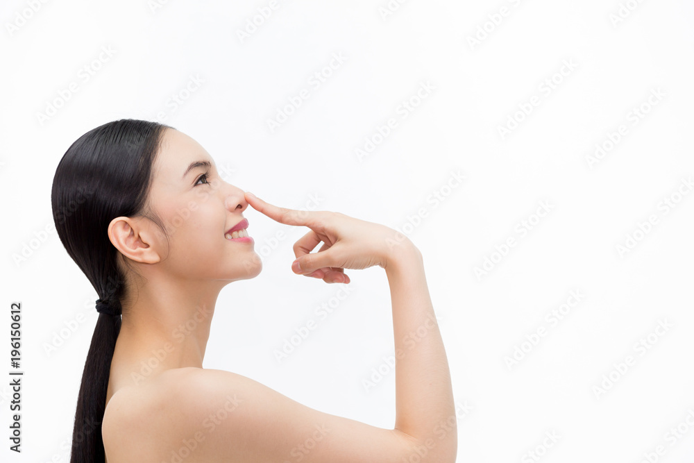 Young attractive woman touching her nose with fingertip over isolated ...
