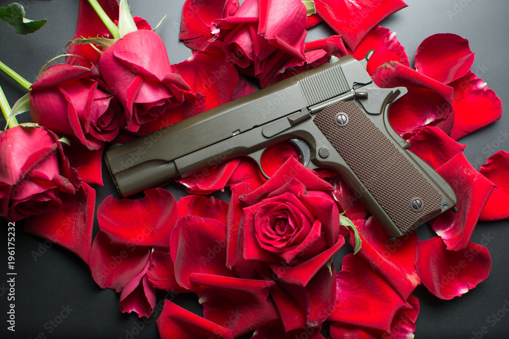 Gun and red roses flower on dark background Stock Photo | Adobe Stock