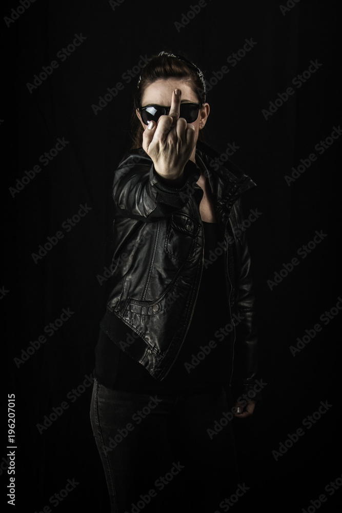 Tough woman in a black leather jacket and sunglasses holding up her ...