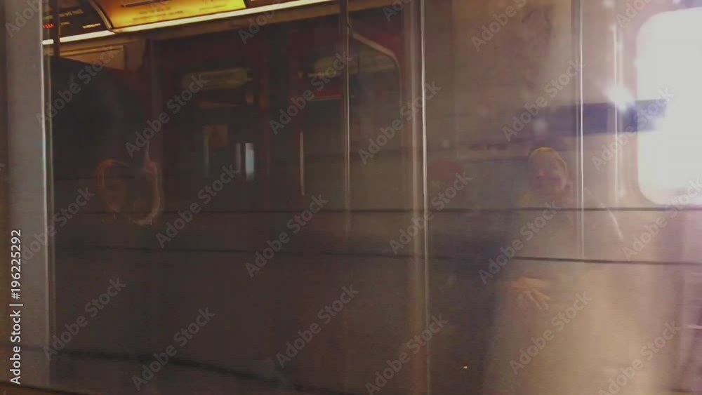 Rolling, bumpy passenger POV looking out window of subway train at ...