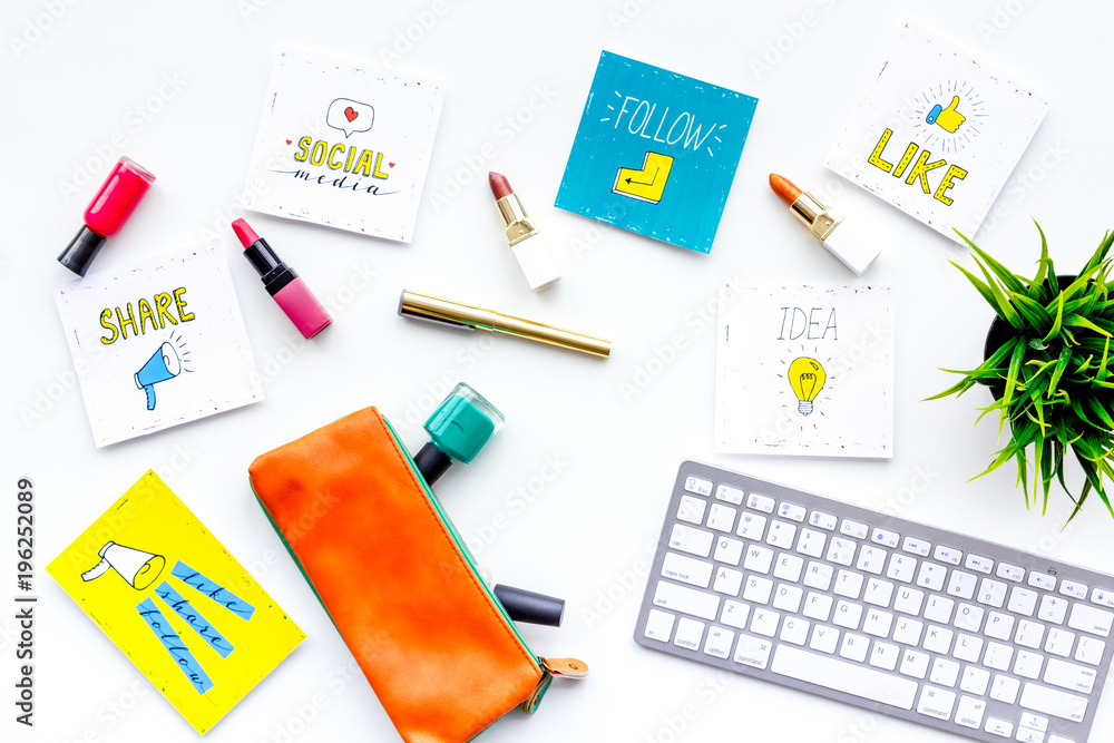 Female blogger concept. Work desk with keyboard, cosmetics and social ...