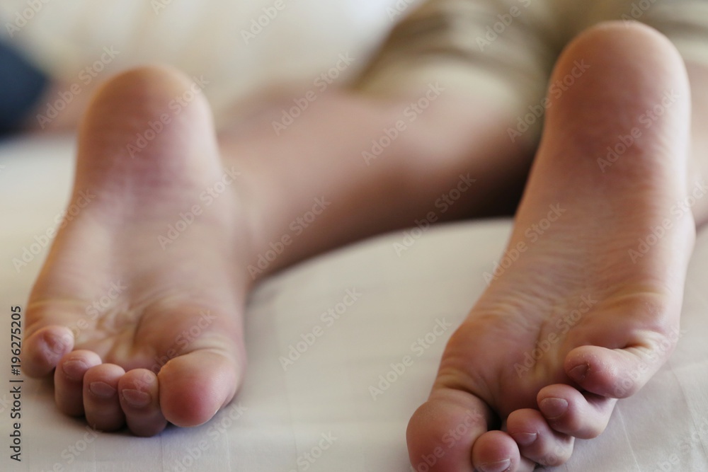People foot closeup laying on bed blur background Stock Photo | Adobe Stock