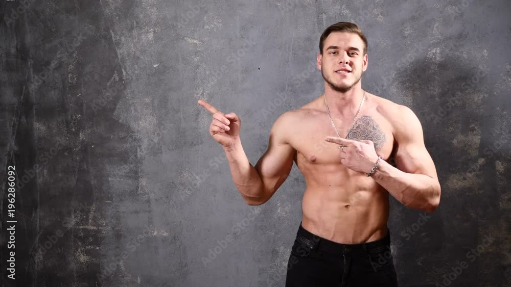 Strong and Muscular man bodybuilder. Man posing on a black background ...