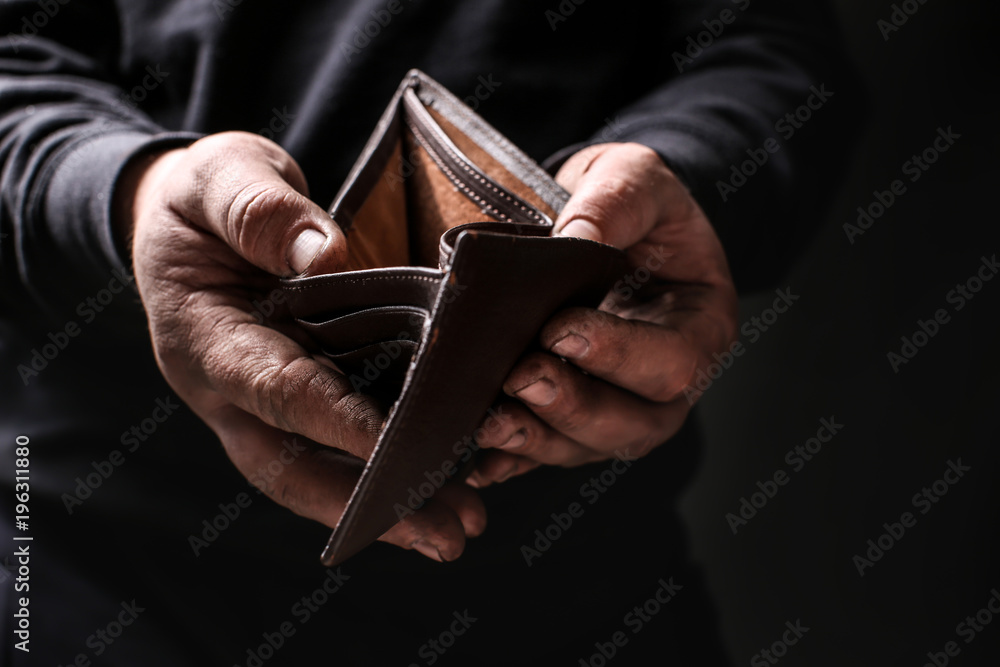 Poor man showing his empty wallet on black background Stock Photo ...