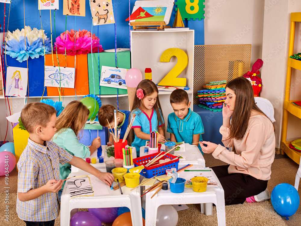 Small students with teacher painting in art school class. Child drawing ...