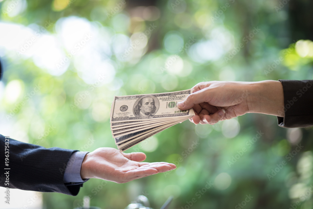 Corrupted two businessman sealing the deal with a handshake and ...