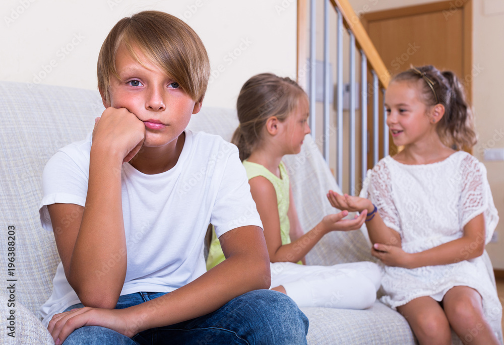 Little sisters ignoring big brother. Stock Photo | Adobe Stock