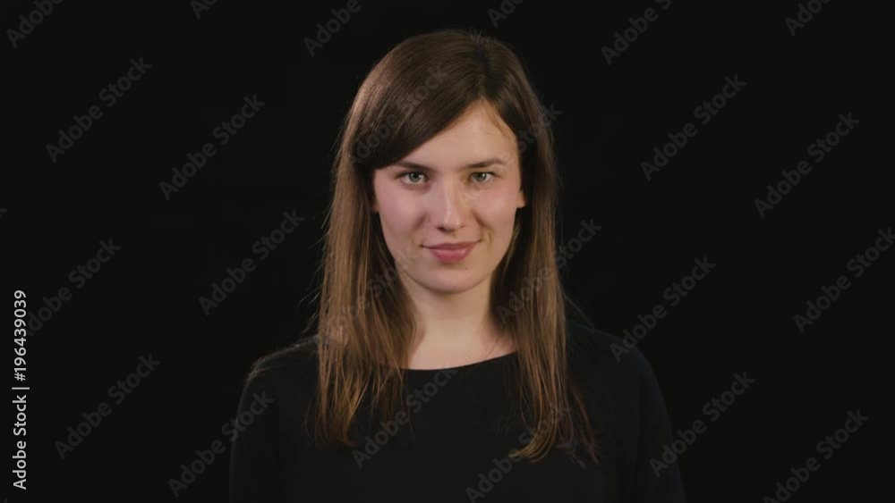 A beautiful young lady showing a shhh meme against a black background ...
