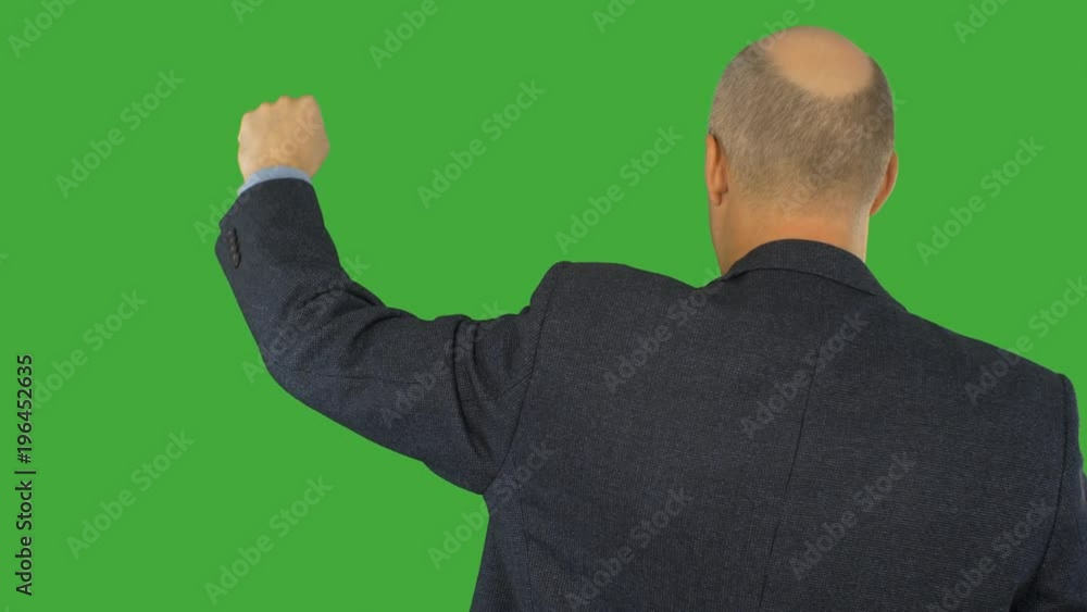 Man moving clenched fist up on left hand on green chroma key background ...
