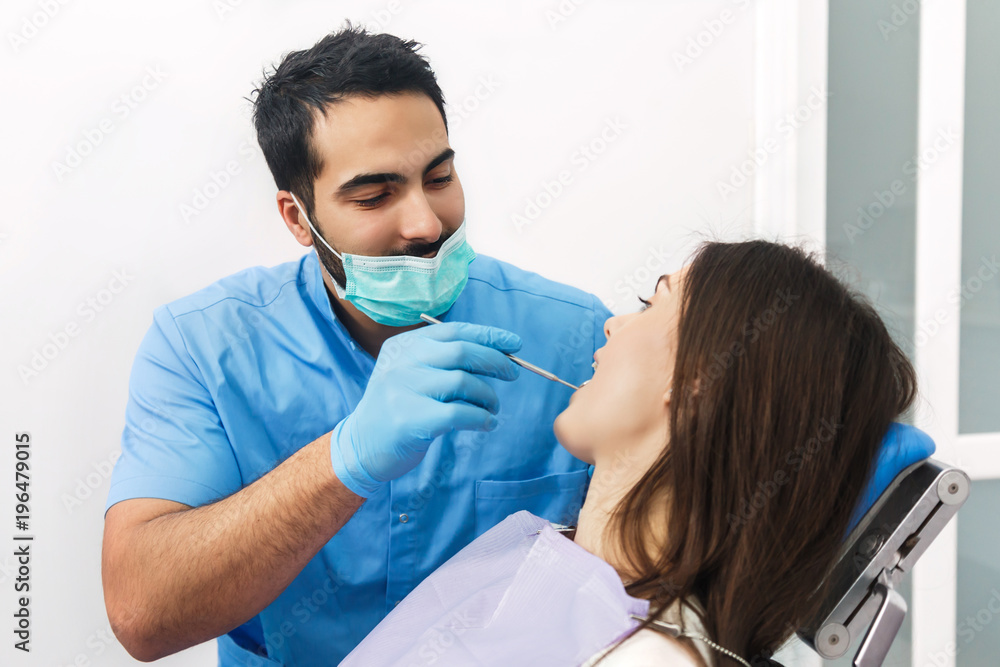 Dentist checking teeth, young asian man, in blue uniform and gloves ...