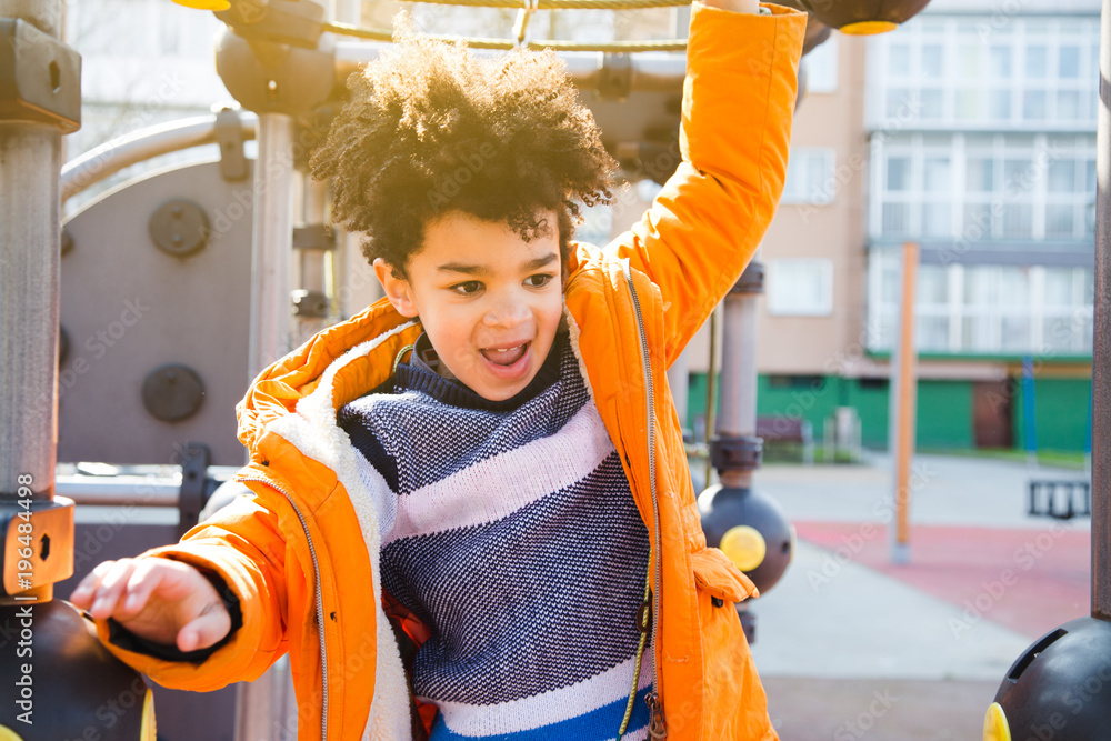 Happy little boy having fun in the playground Stock Photo | Adobe Stock