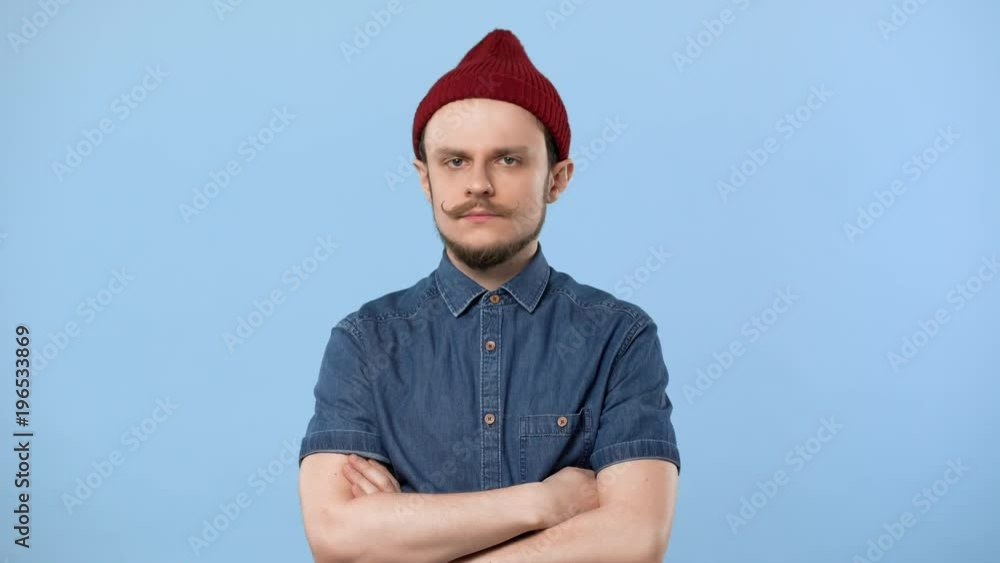 Portrait of strict man with trendy appearance standing with hands ...