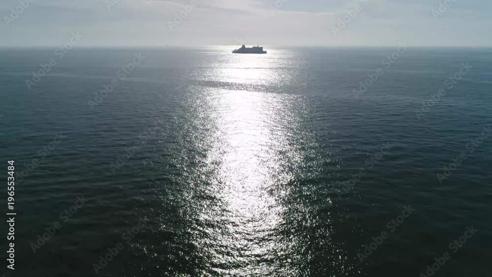 Aerial bird view footage of large ship moving over ocean in sun ...