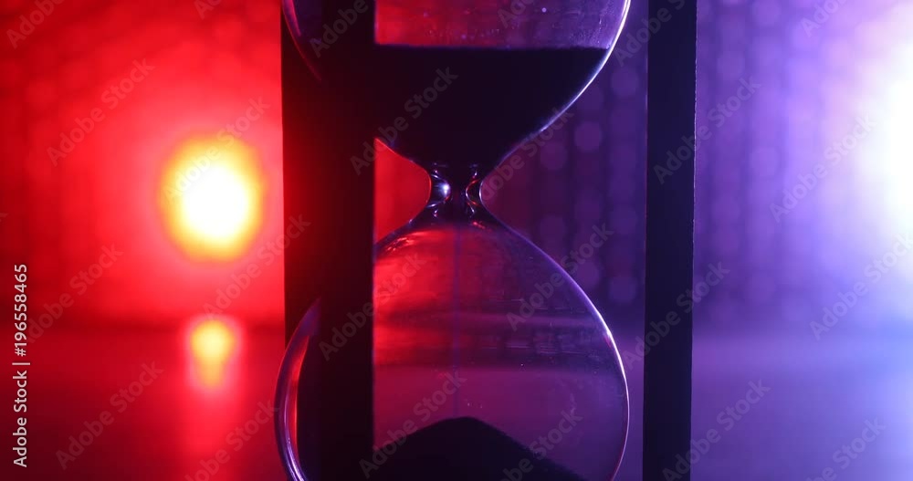 Time concept. Silhouette of Hourglass clock on dark toned backlight ...