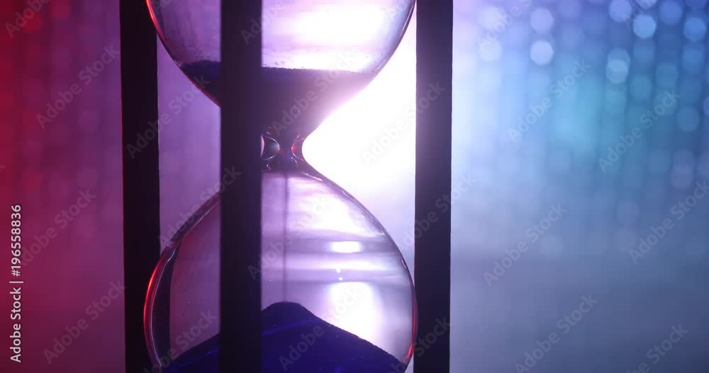 Vidéo Stock Time concept. Silhouette of Hourglass clock on dark toned ...