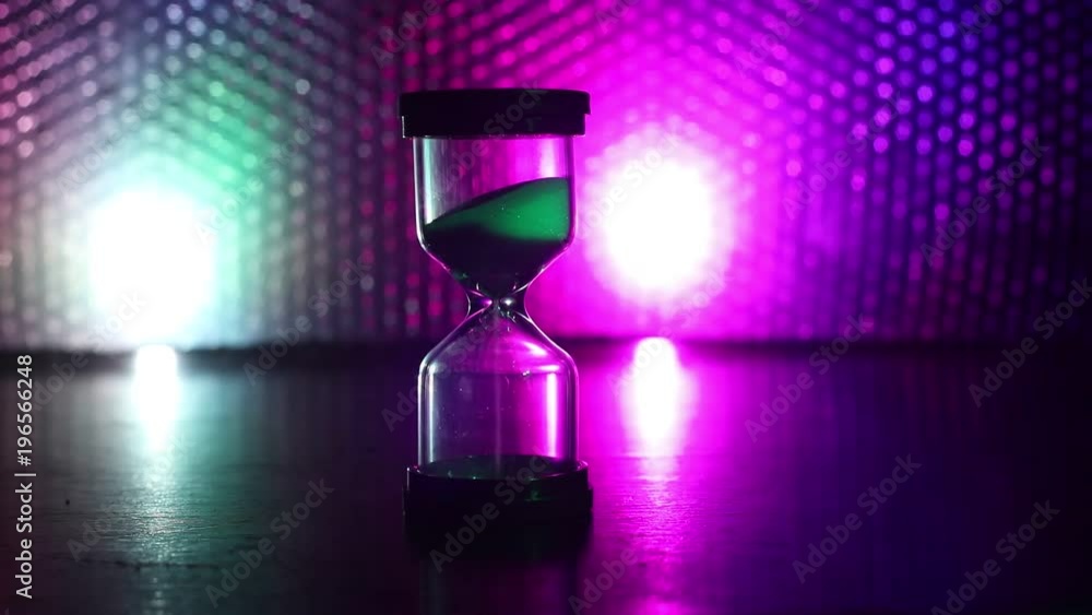 Time concept. Silhouette of Hourglass clock on dark toned backlight ...
